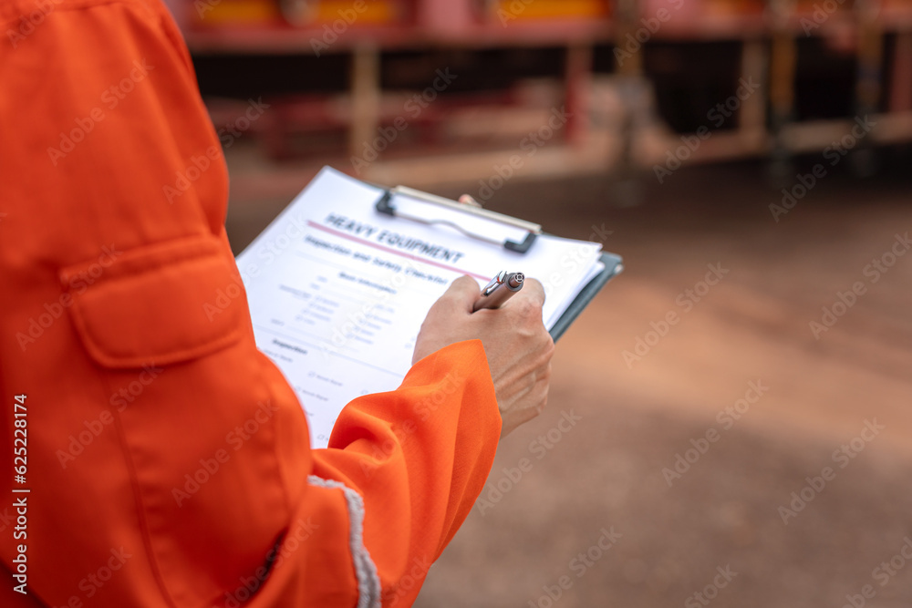 Close-up at the operation supervisor is checking on heavy machine and ...
