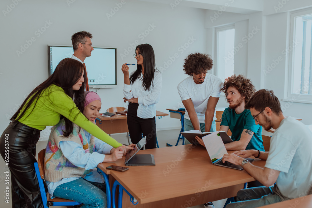 A diverse group of students gathers in a modern school classroom ...