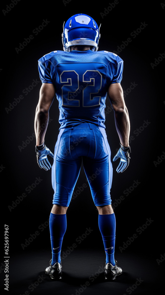 rear view of american football athlete in blue uniform standing in ...