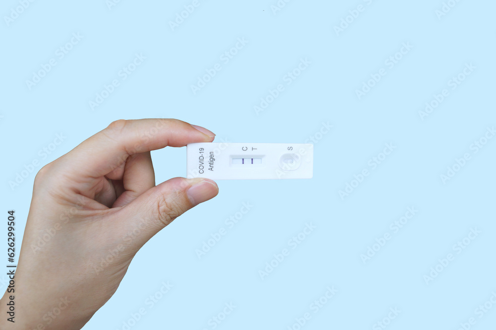 Hand holding Covid-19 Positive test result (Two Strips) with SARS CoV-2 ...