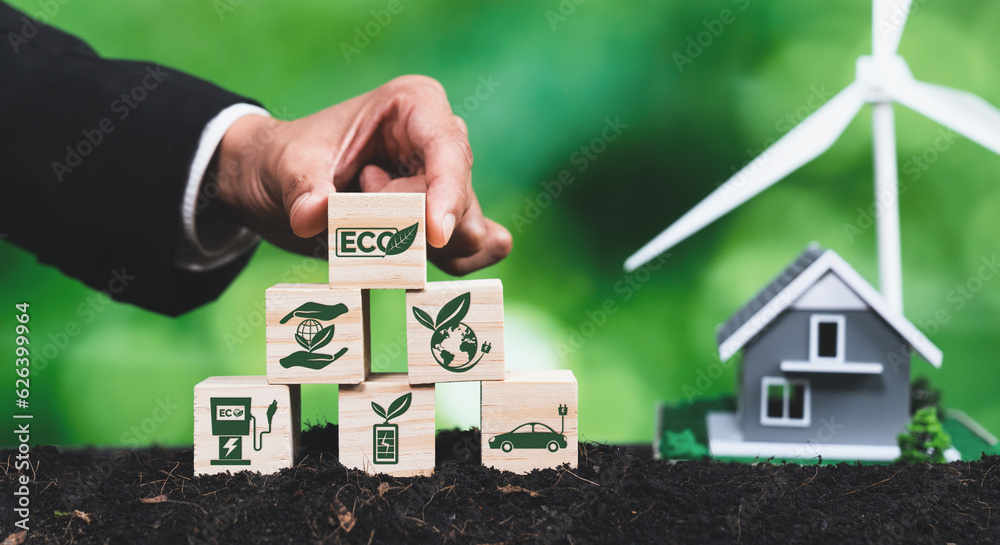 Businessman put ECO cube symbol on pyramid top stack with house and ...