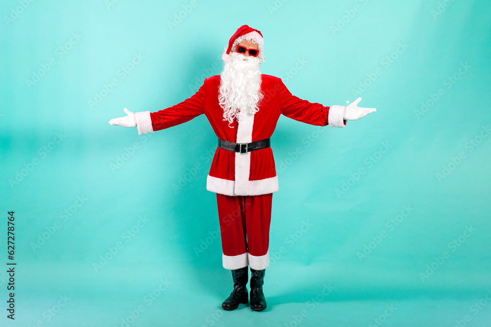 young guy in santa claus costume spreads his arms to the sides and ...