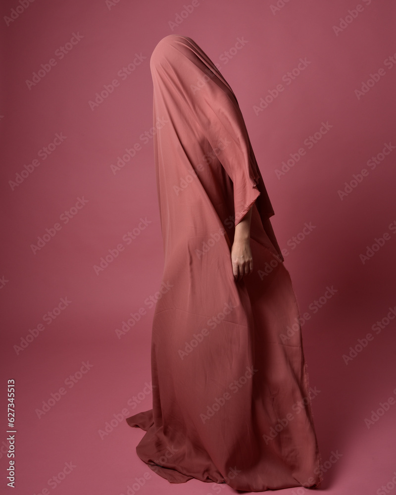 Portait of beautiful woman wearing gown of draped silk fabric, standing ...