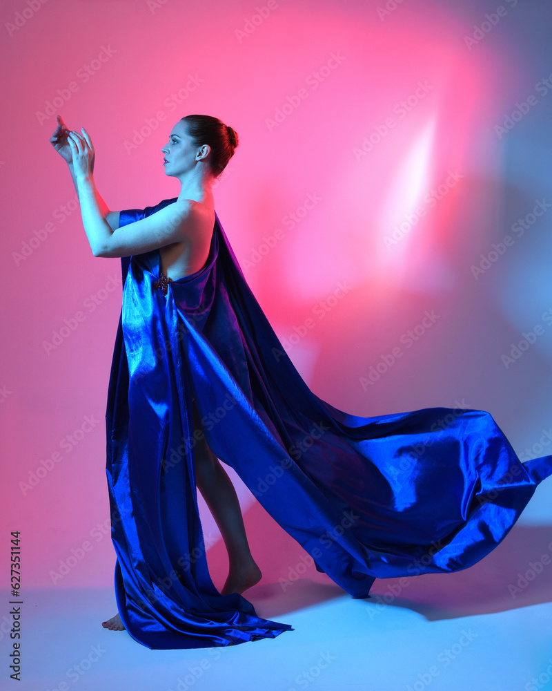 Full length portrait of beautiful female model wearing elegant flowing ...