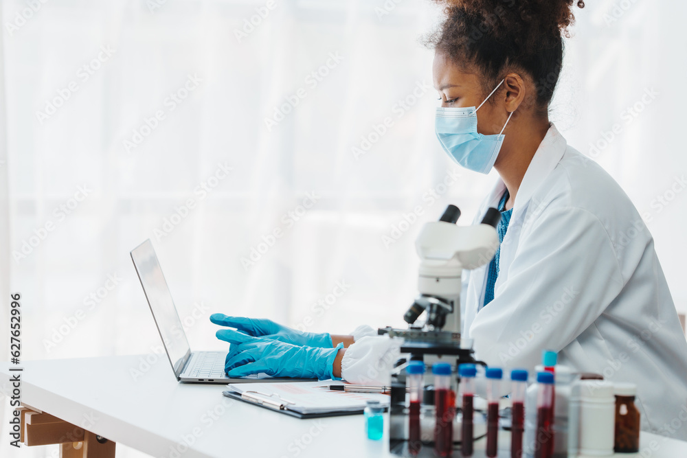 Photo Stock African American female technician testing blood sample in ...