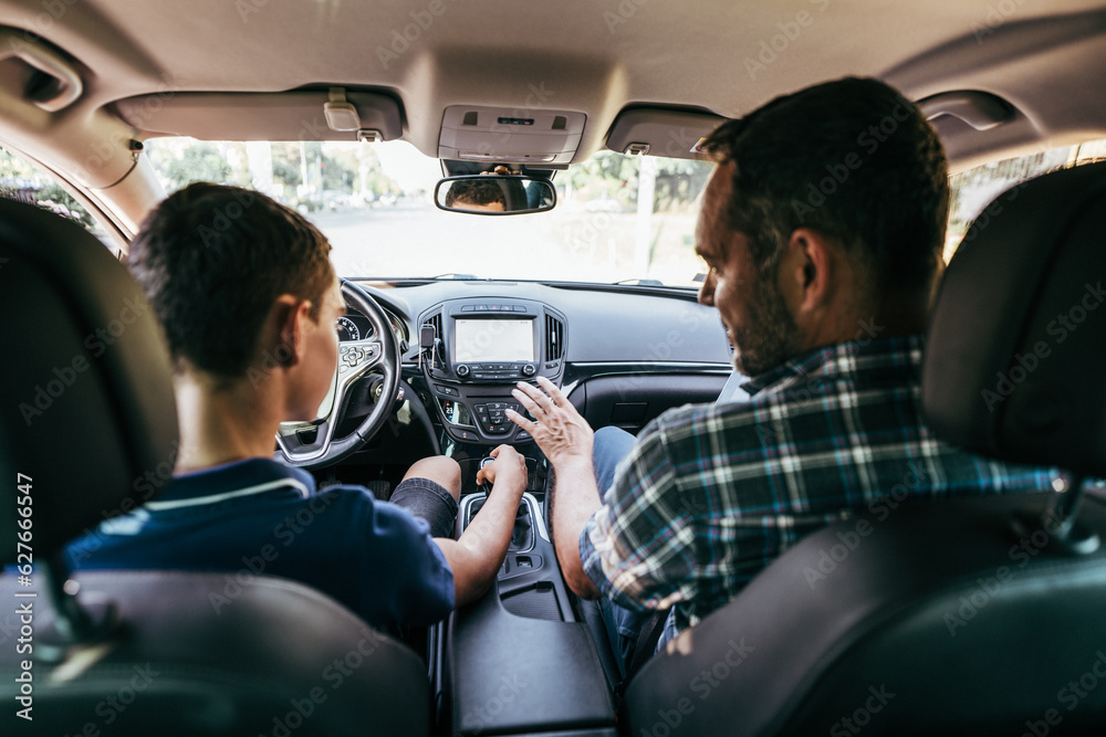 Driving instructor sitting his student and explain to him car driving ...