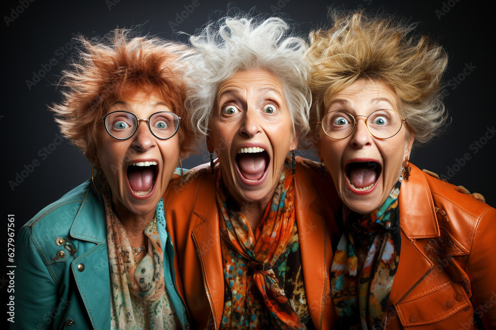 Funny portrait of three senior shocked women looking at camera keeping ...