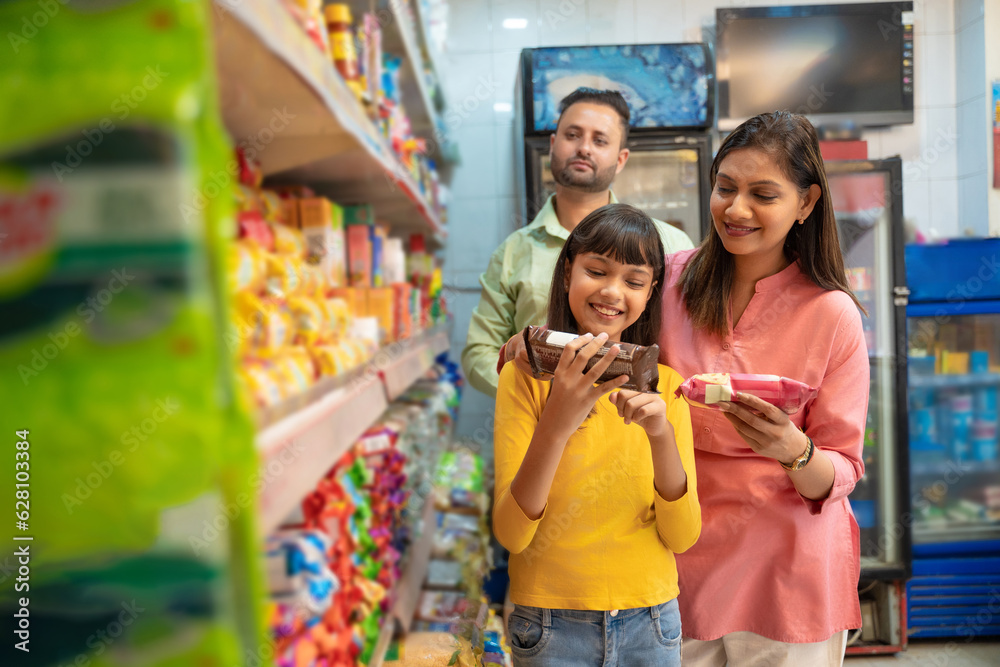 Indian family doing shopping together and choosing product at grocery ...