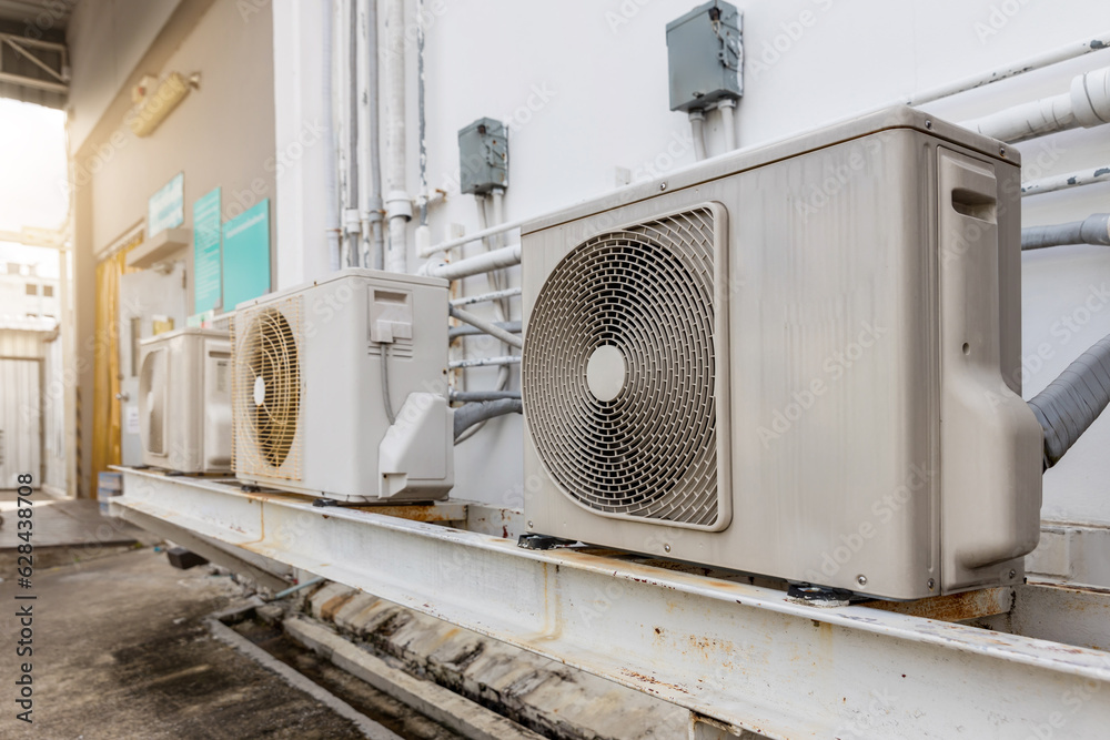 Air conditioner compressor installed in old building. Outdoor split ...