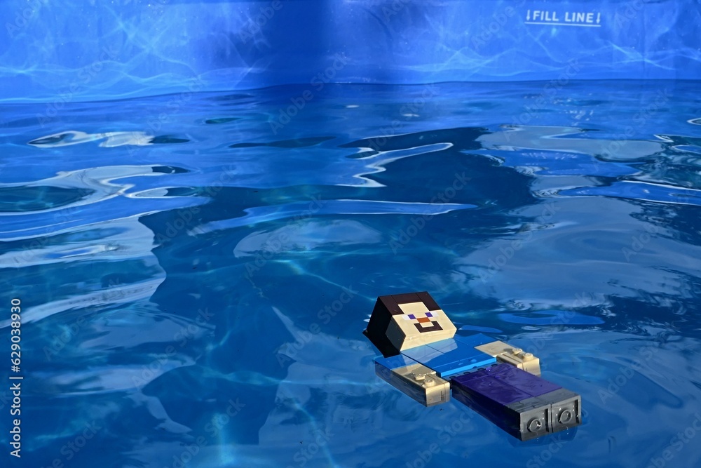 Stock-Foto „LEGO Minecraft figure of Steve swimming backstroke in ...