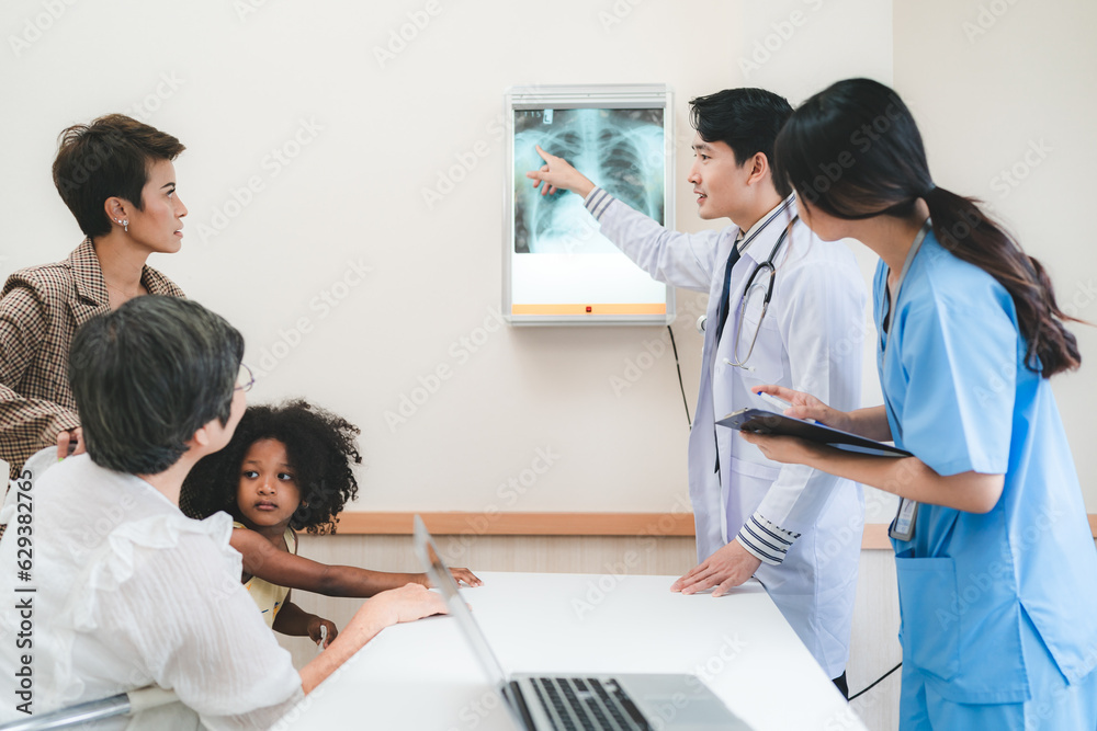 A team of young Asian male doctor and female nurse in lab coat with stethoscope in conversation ...