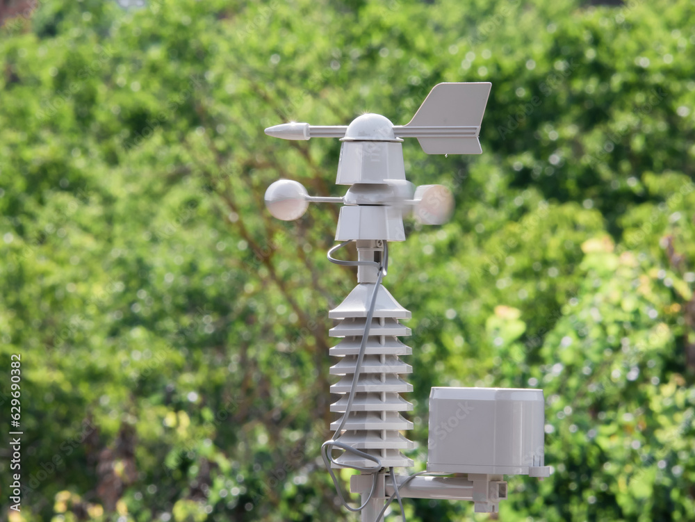 Weather vane marking the direction of the wind and anemometer (wind ...