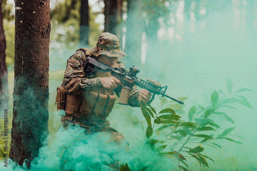A modern warfare soldier on war duty in dense and dangerous forest areas. Dangerous military ...