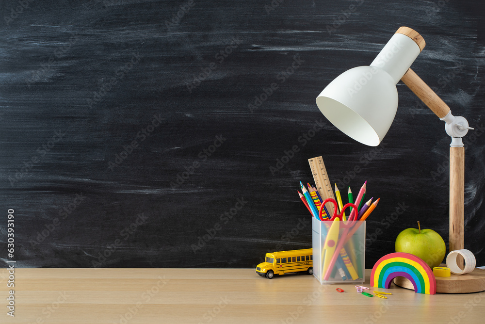 Classroom setup. Side view photo of stationery organizer, lamp, rainbow ...