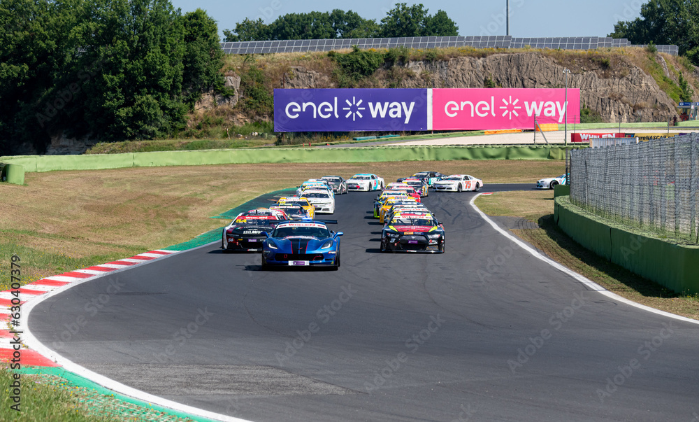 Nascar racing cars group aligned during race formation lap behind ...
