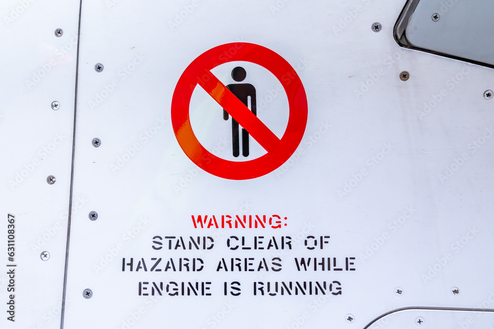ภาพถ่าย Stock Sign with red symbol on jet engine with accompanying ...