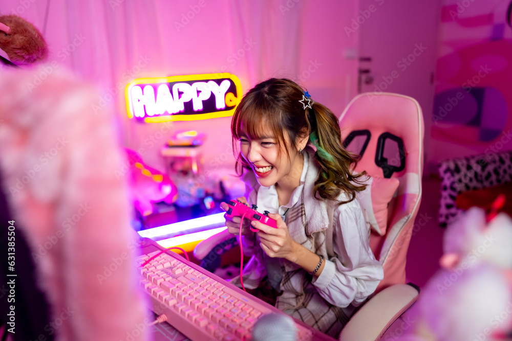 Young Asian woman esport player playing online game on computer in ...
