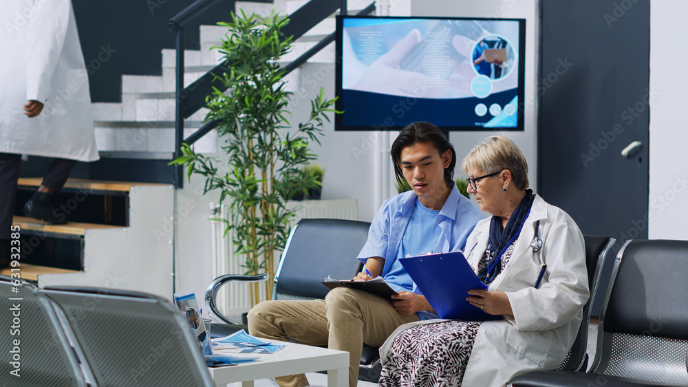 Doctor helping patient to fill medical files during checkup visit ...