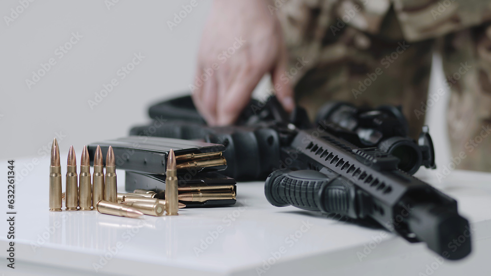 Stock-Foto „Hand taking ammo, bullets 762 caliber for ak47, gun crime ...