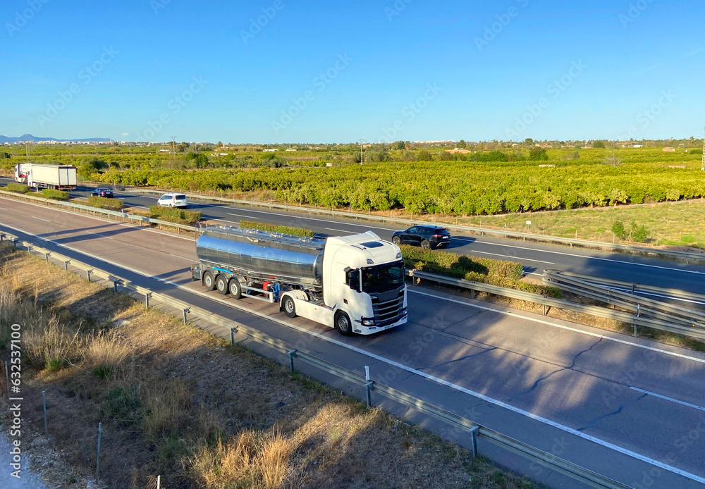 Isothermal Tank truck driving on highway. Oil and Gas Transportation ...