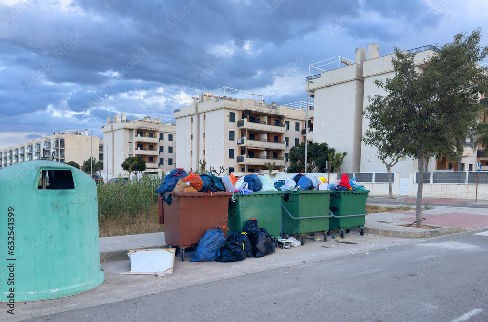 Dumpster for Garbage and food waste on city Spain street. Plastic bags ...