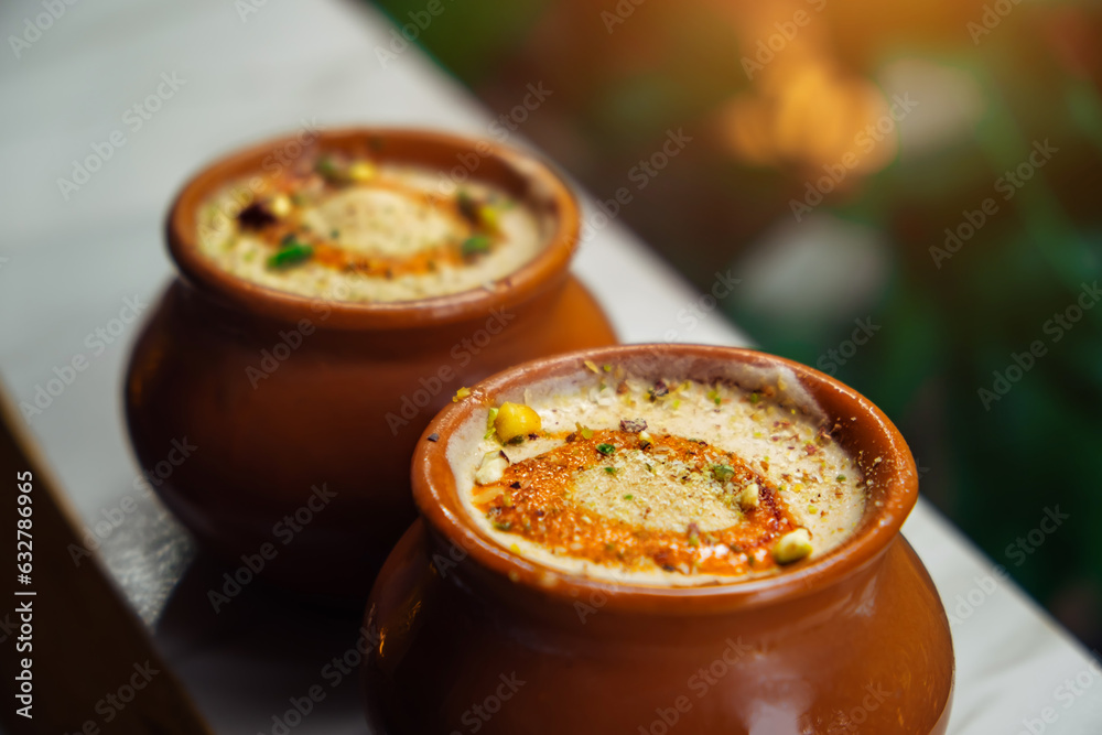 Kulfi or Qulfi ice cream in a clay pot. Kulfi is a popular traditional ...