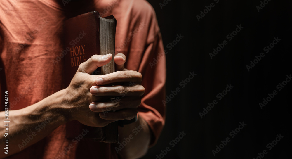 young man sitting and praying Pray the Holy Scriptures in the ...