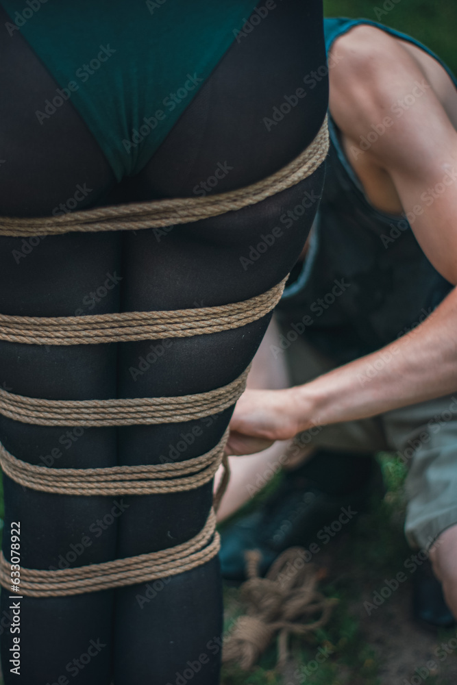 buttocks of beautiful redhead woman in green body tied with shibari ...