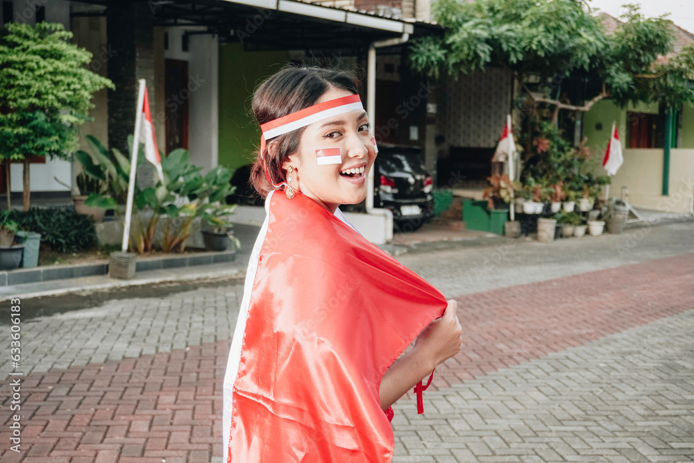 Happy smiling Indonesian woman wearing red kebaya holding Indonesia's ...