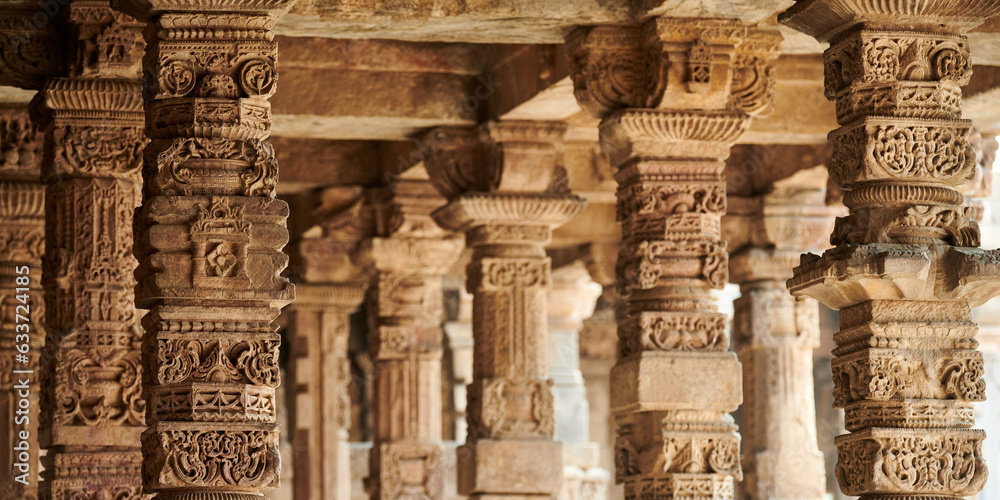 Stone columns with decorative bas relief of Qutb complex in South Delhi ...