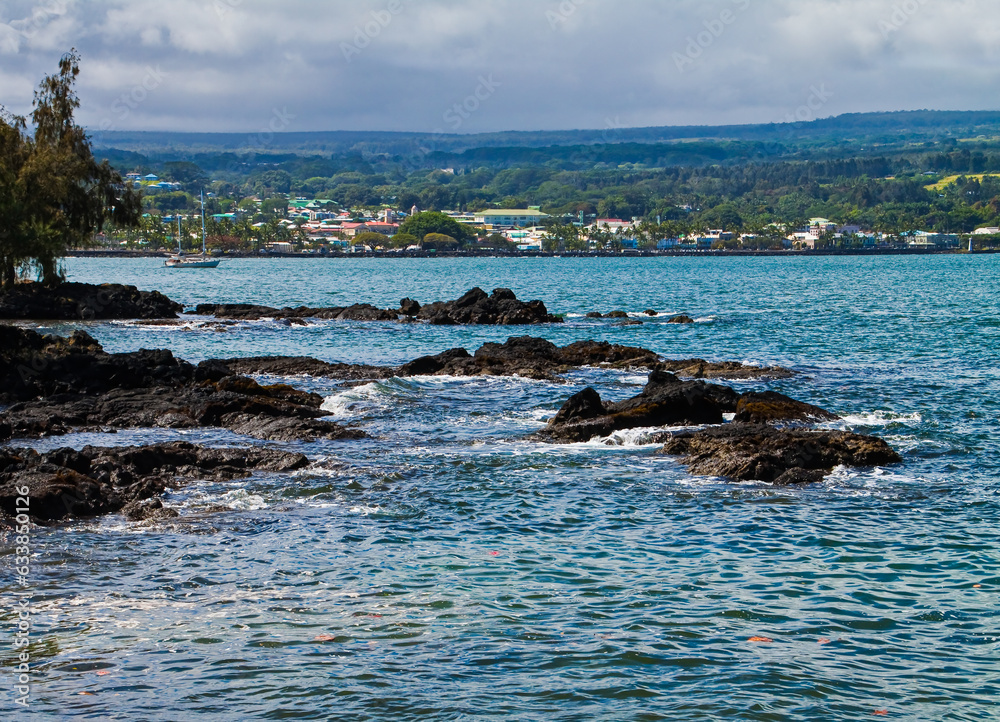 Sailboat in Hilo Bay With Downtown Hilo and The Lava Filled Shoreline ...