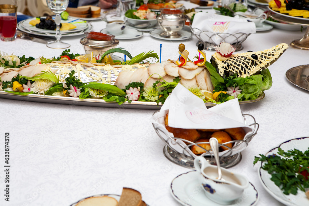 Russian-style table, dishes with caviar, cold cuts, fruits, vegetables ...