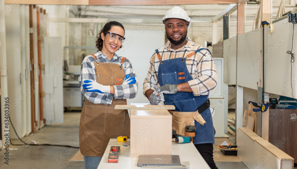 Two confident young carpenter teamwork coworker colleague standing look ...