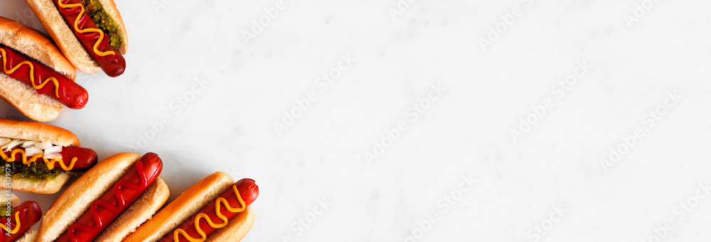Variety of hot dogs with an assortment of toppings. Overhead view ...