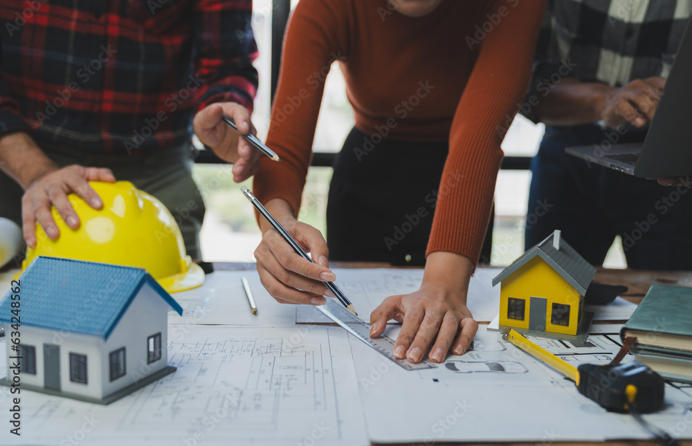 Architect designing house checking house plans engineering team working with blueprints Planning ...