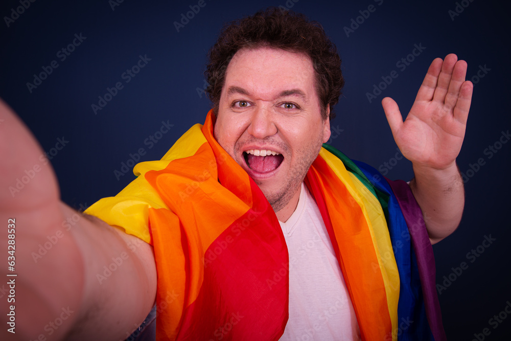 Funny fat man with a rainbow flag posing in the studio. Fight for your ...