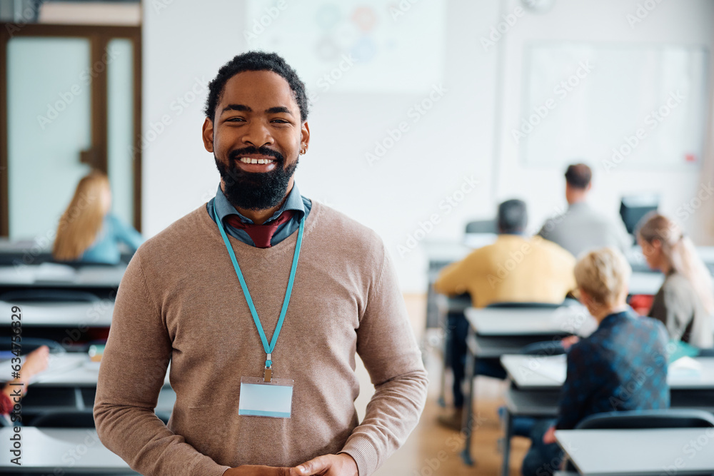 Happy black professor during class with adult students in classroom ...