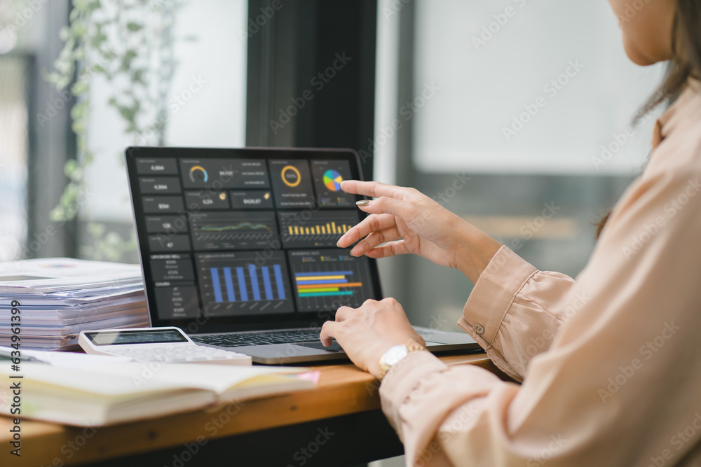 The female analyst utilizes a computer and a dashboard for business ...