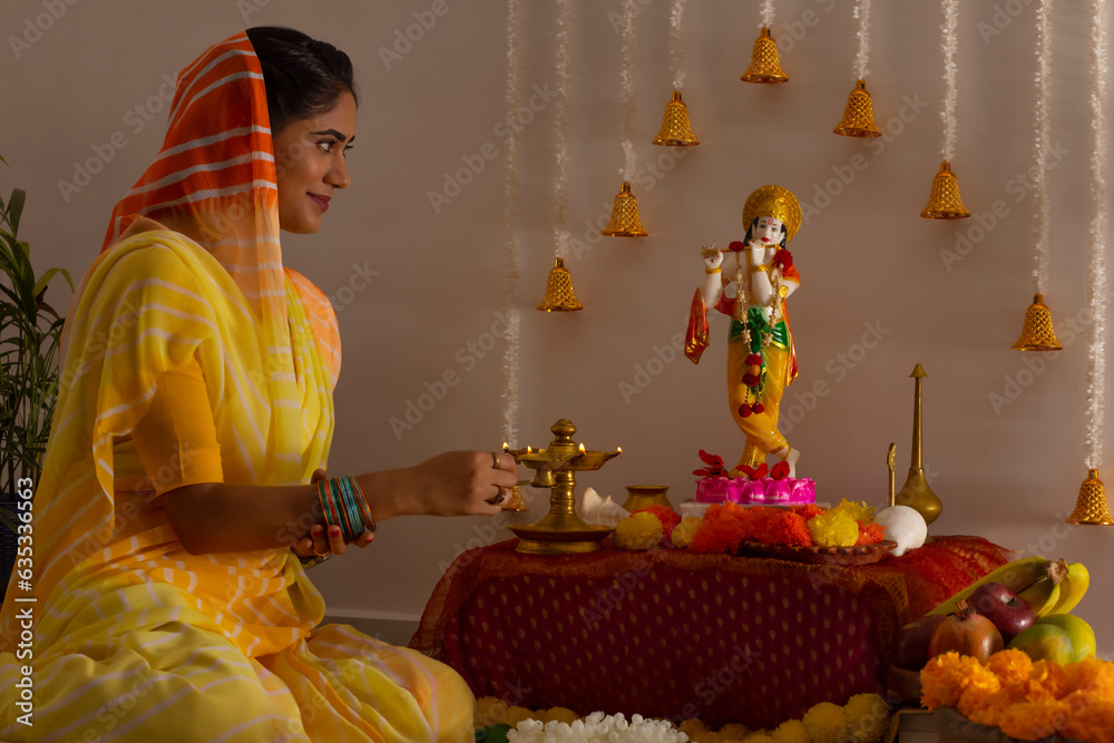 Woman worshipping Lord Krishna on the occasion of Janmashtami Stock ...