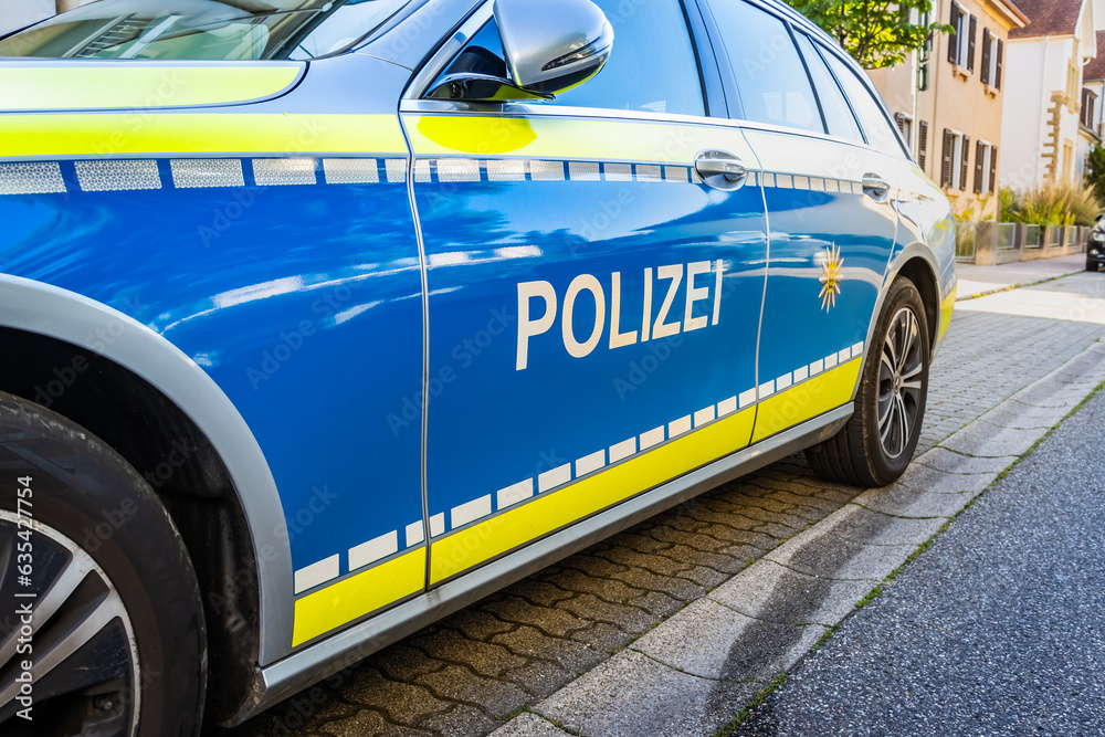 German police car on a street. Side view of a police car with the ...