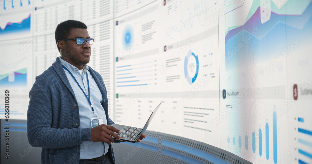 Confident Black Businessman Holding Laptop And Reviewing Financial ...