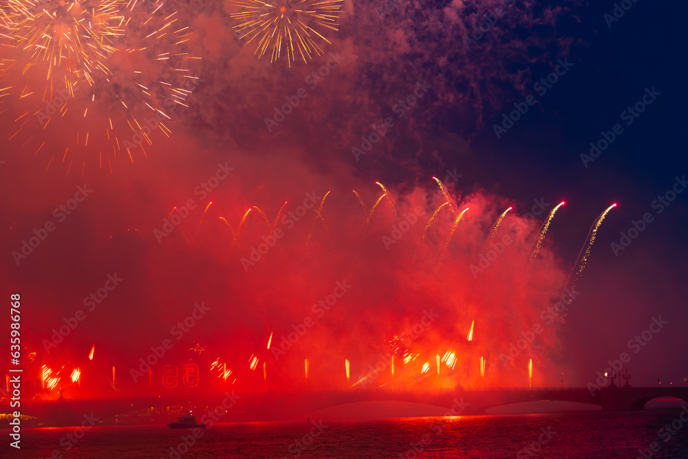 Beautiful red firework explodes in night city sky above bridge ...