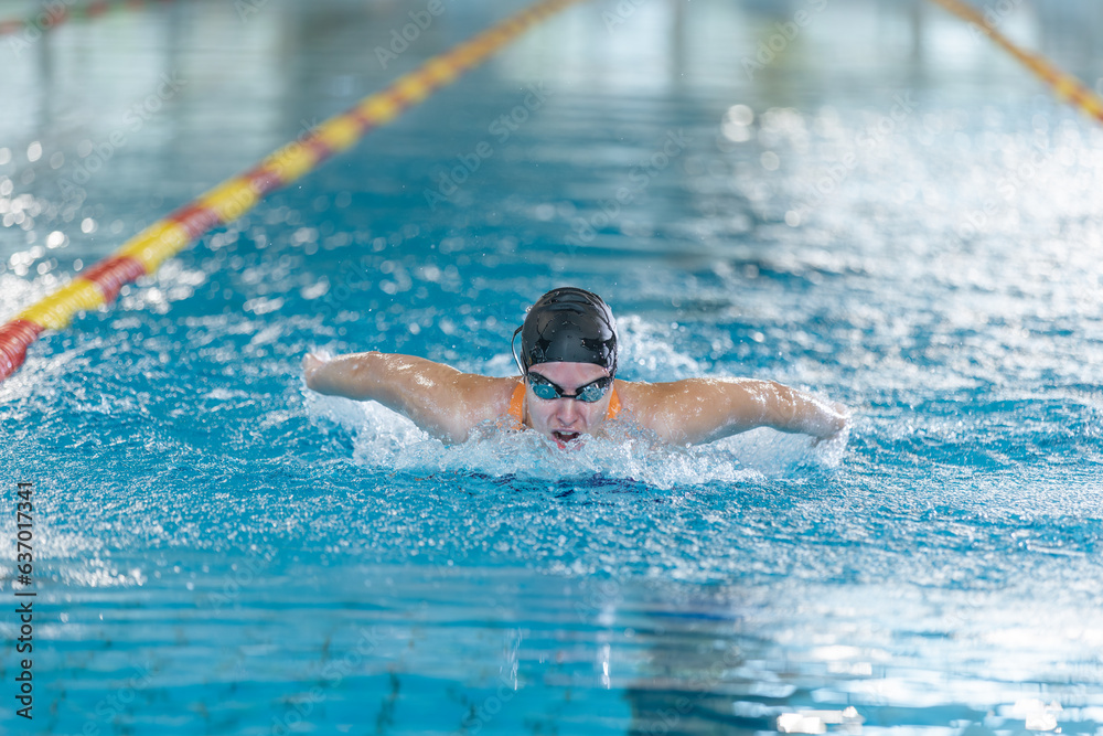 Female competitive swimmer moving through the water performing the ...