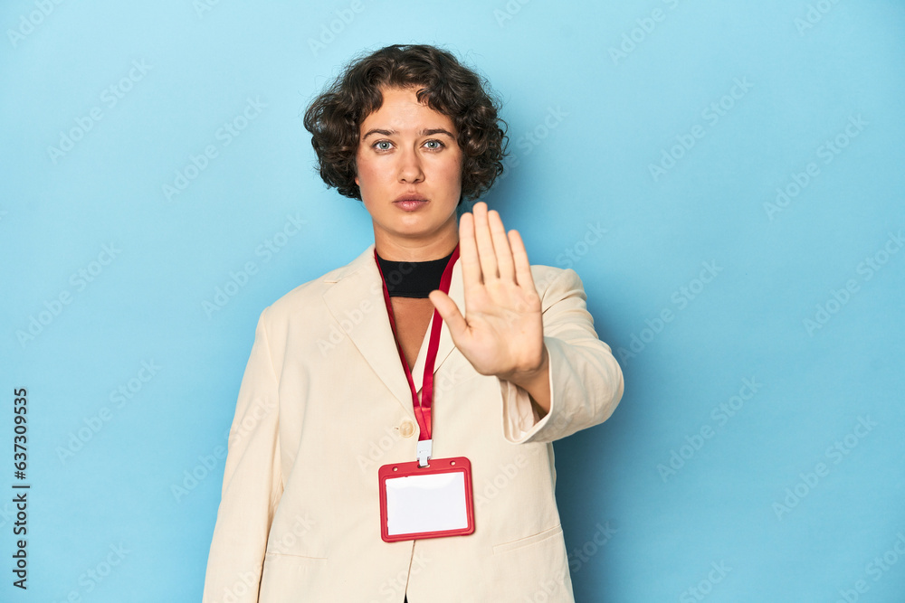 Young woman holding identification card for event standing with ...