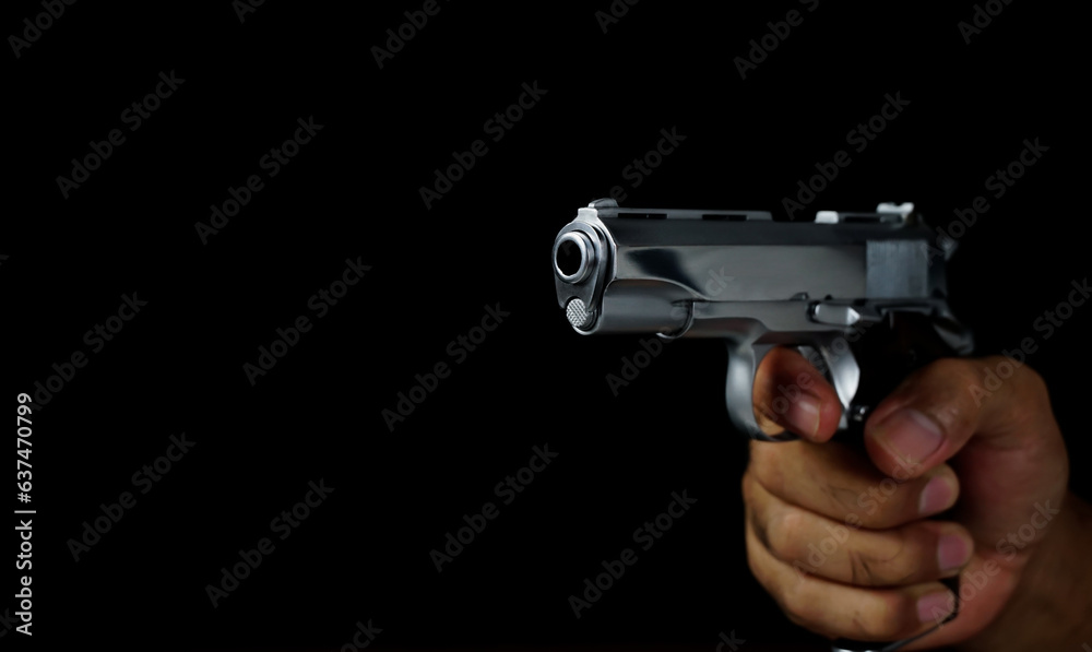 Male hand holding a gun on black background . Pistol in a man's hand ...