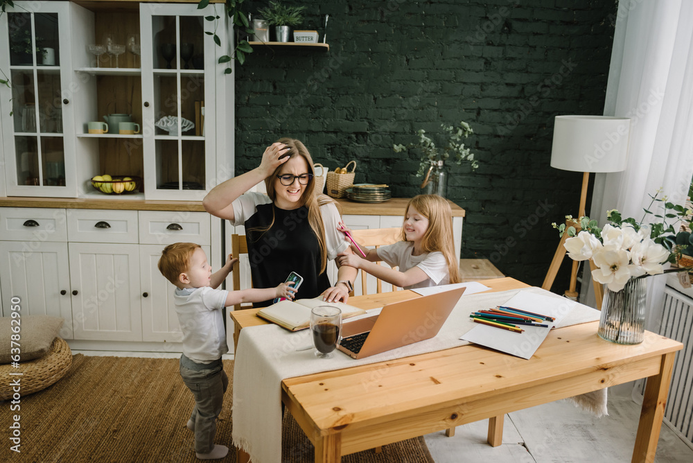 Angry and tired woman. Mother working with kids at home. Woman working ...