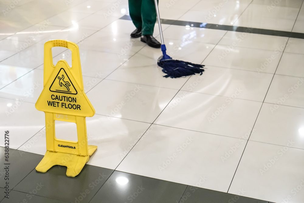 Yellow caution sign saying wet floor prevent people from falling on ...