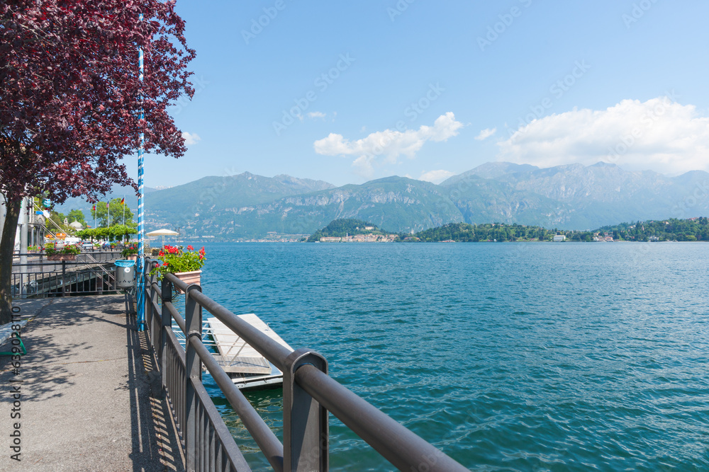 Walkway and railing on edge of Lake Como with distant surrounding ...