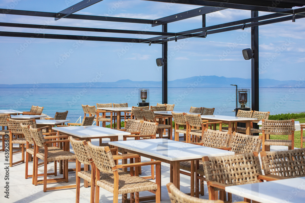 Rattan chairs with tables in a Greek restaurant by the sea. Stock Photo ...
