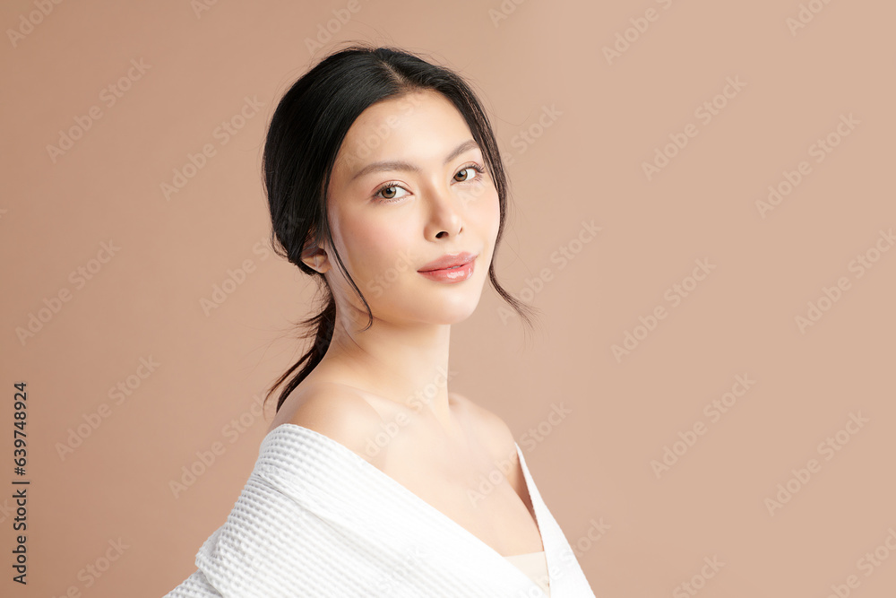 Beautiful young asian woman with clean fresh skin on beige background ...